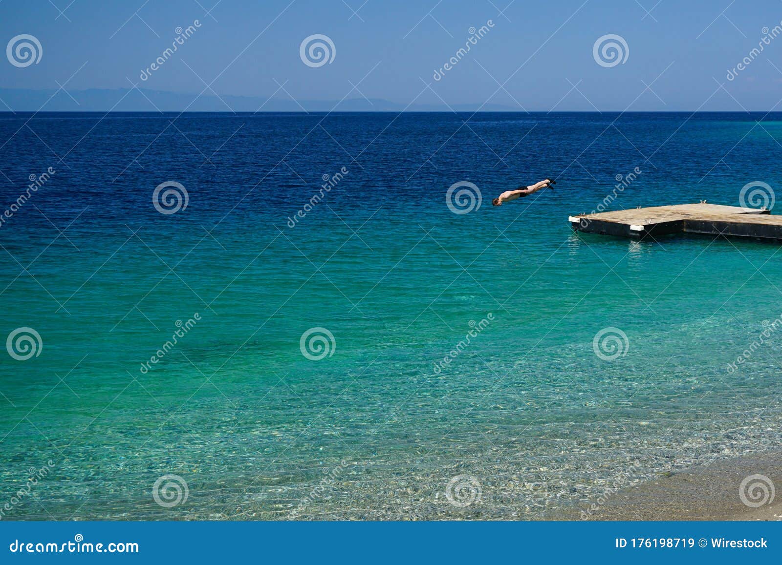 Man Diving Head First into the Ocean from the Dock Stock Image - Image ...