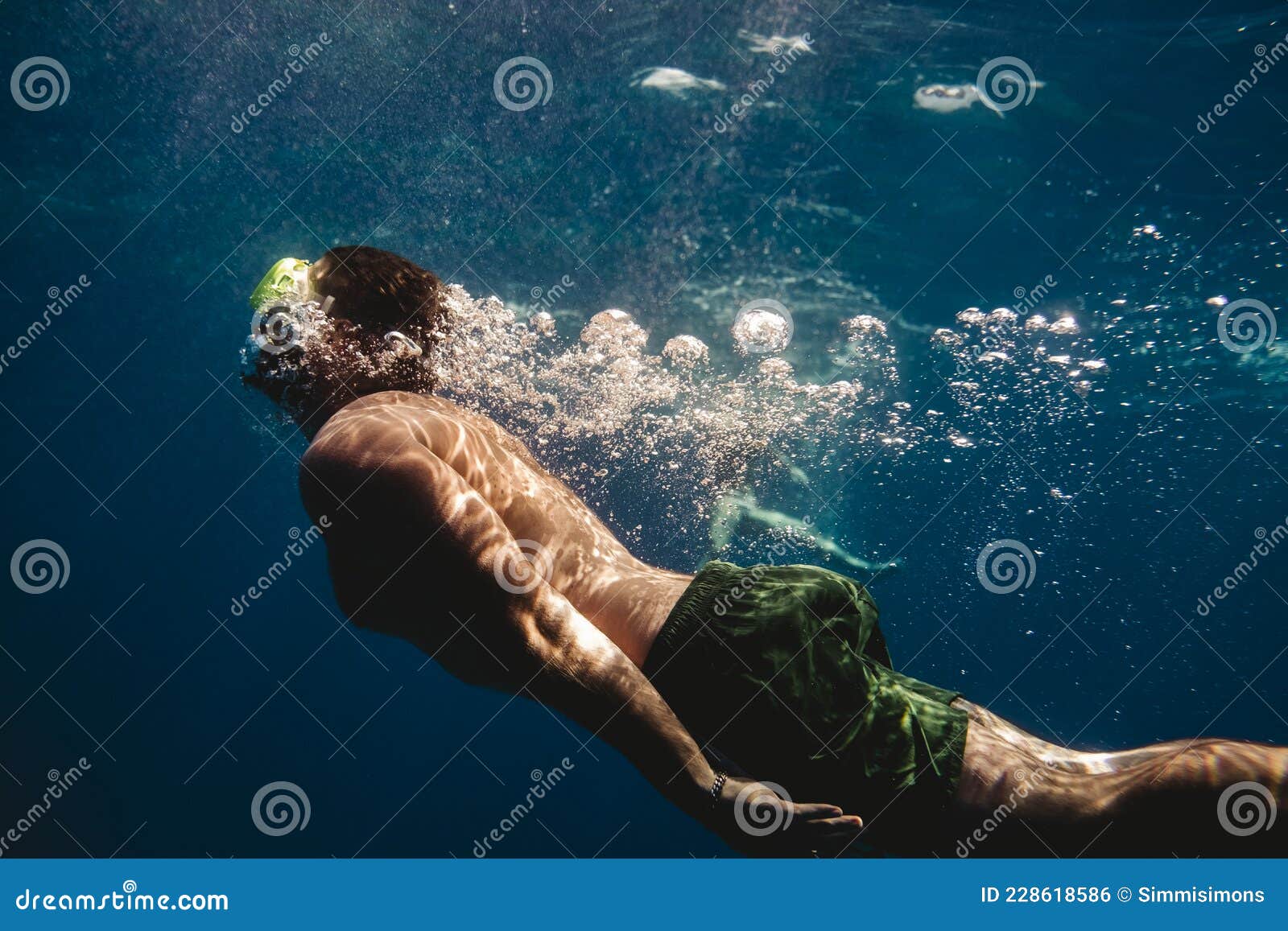 Man diving into the ocean stock photo. Image of underwater - 228618586