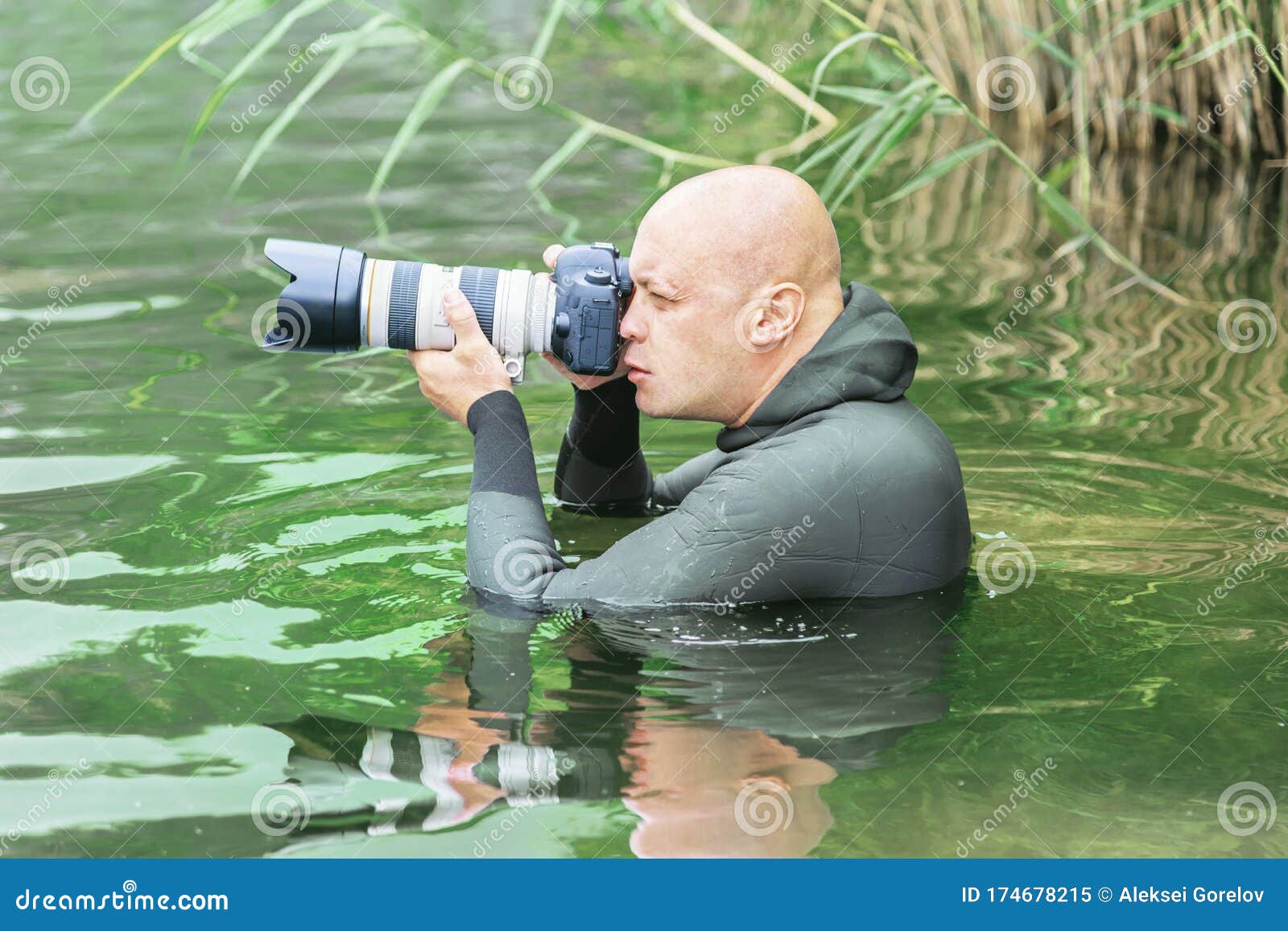 A Man in a Diving Suit in the Water with Slr Camera Stock Image - Image ...