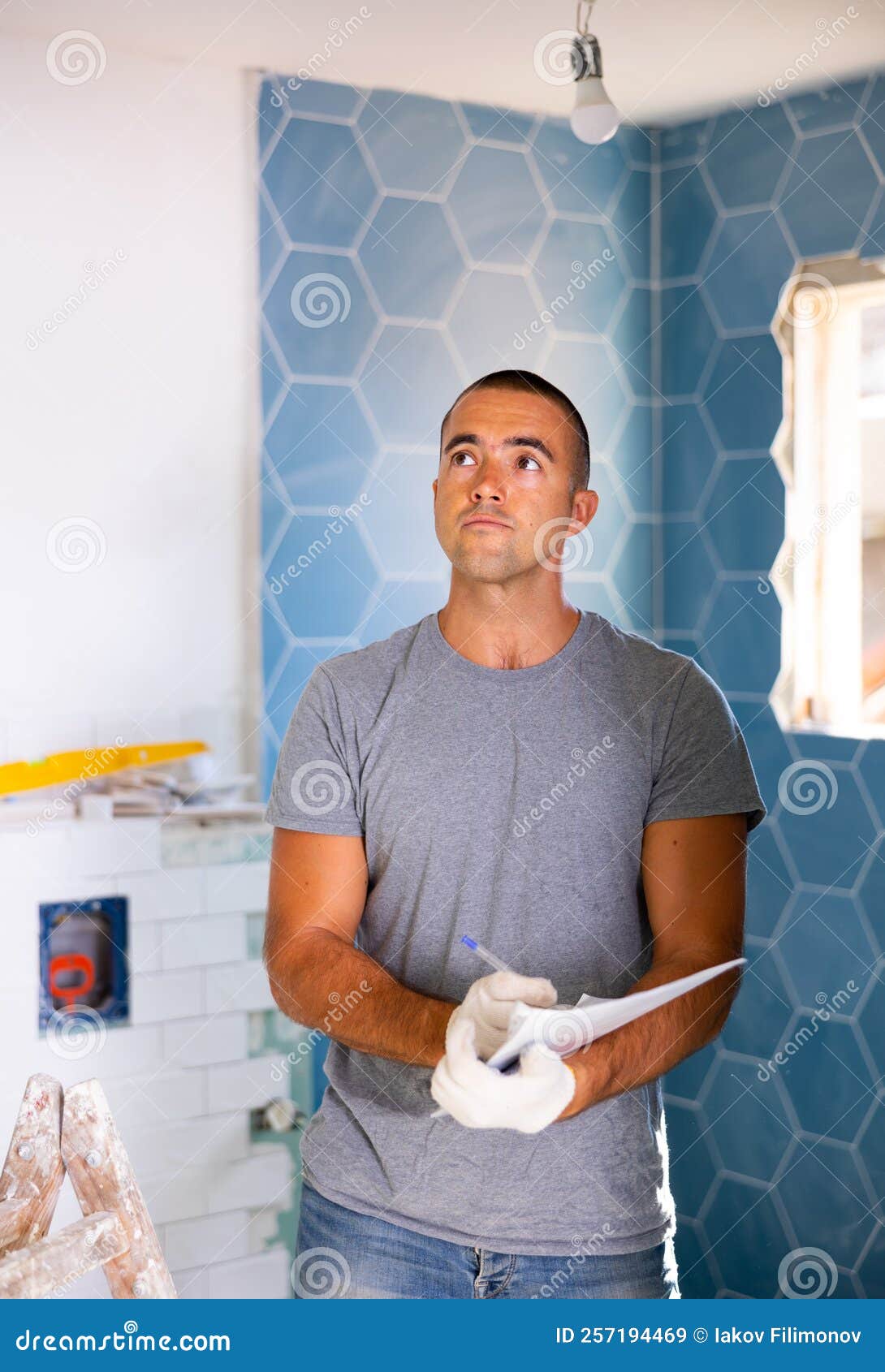 Man with Documents Planning Renovation Works in New Apartment Stock ... Man with Documents Planning Renovation Works in New Apartment Stock ...