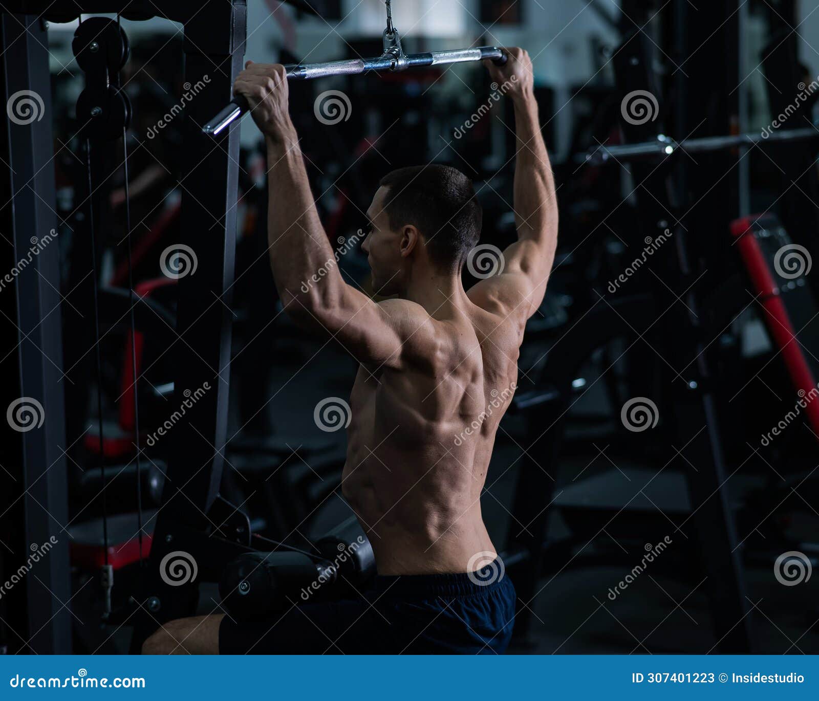 A Man Does a Chest Pulldown in the Gym. Stock Image - Image of pull ...