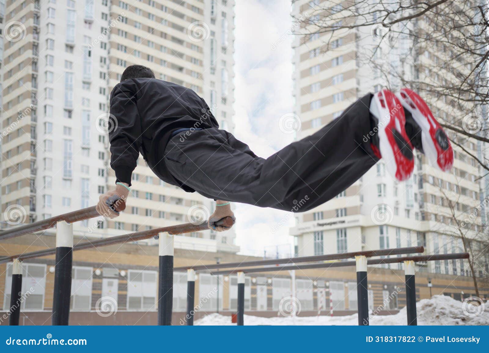 Man Does Exercises on Parallel Bars on Sport Stock Photo - Image of ...