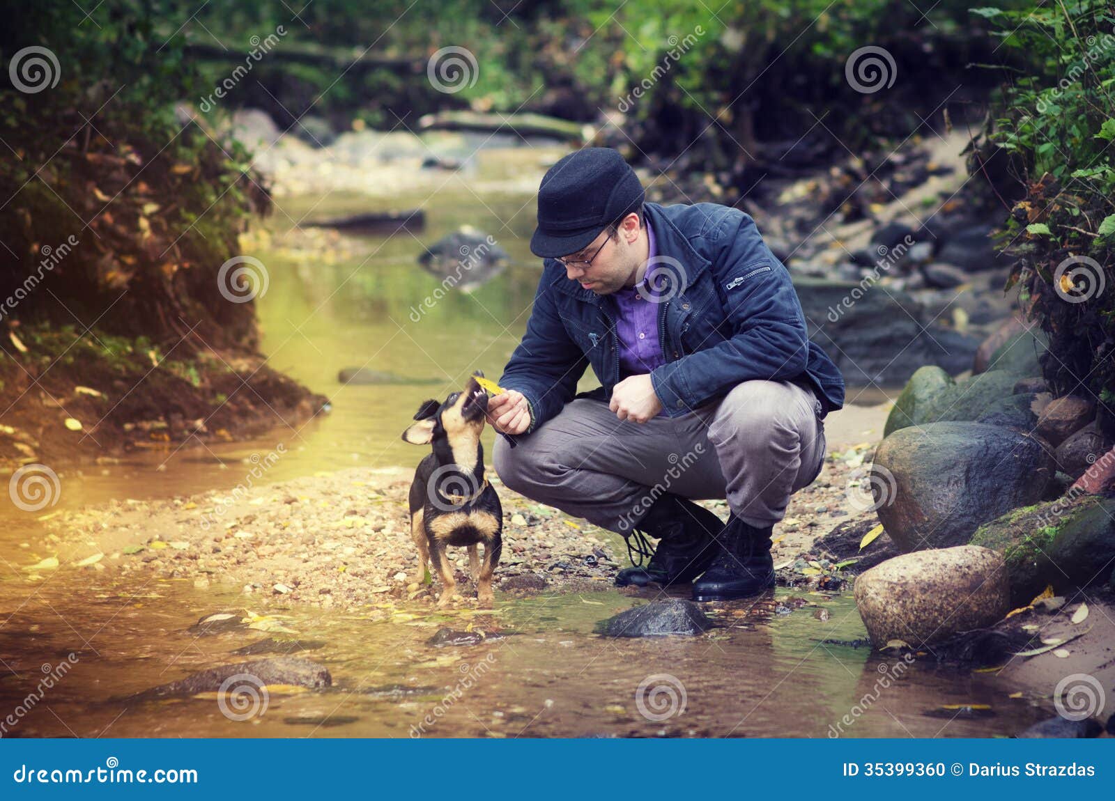 Man with dog at stream stock photo. Image of season, mammal - 35399360