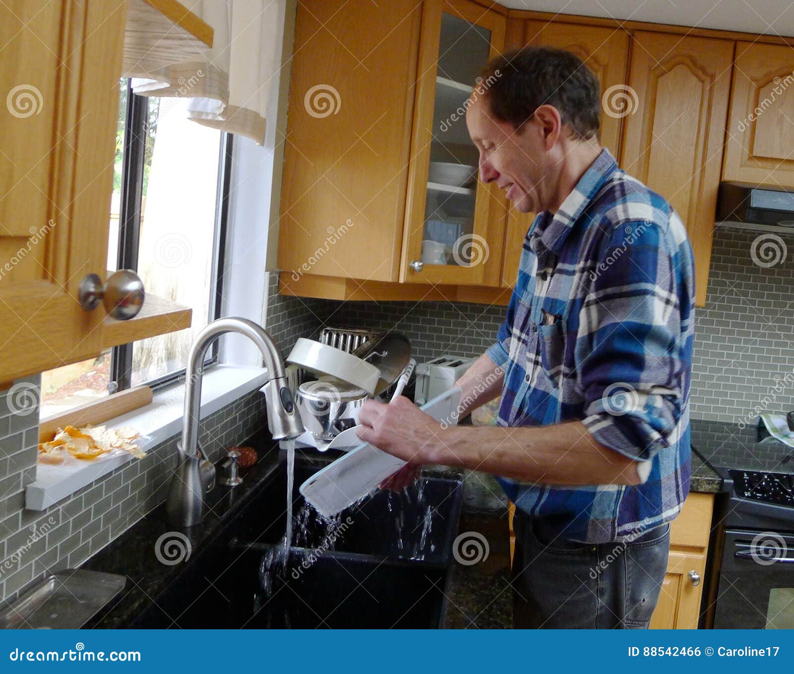 Man Doing Cleaning Work in the Kitchen Stock Photo - Image of shirt ...