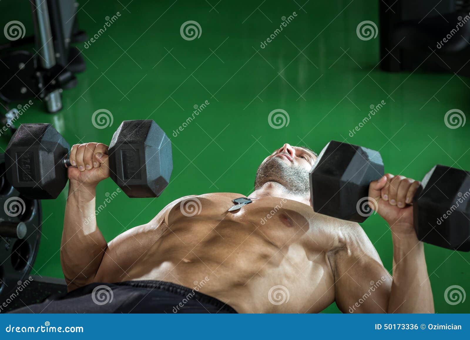 Man Doing Dumbbell Press while Lying Down Stock Photo - Image of ...