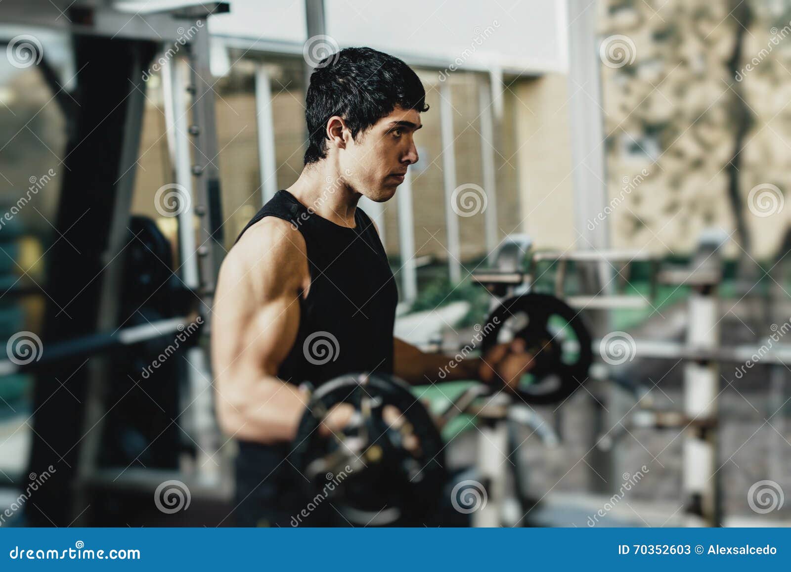 Man doing exercise in gym stock image. Image of biceps - 70352603