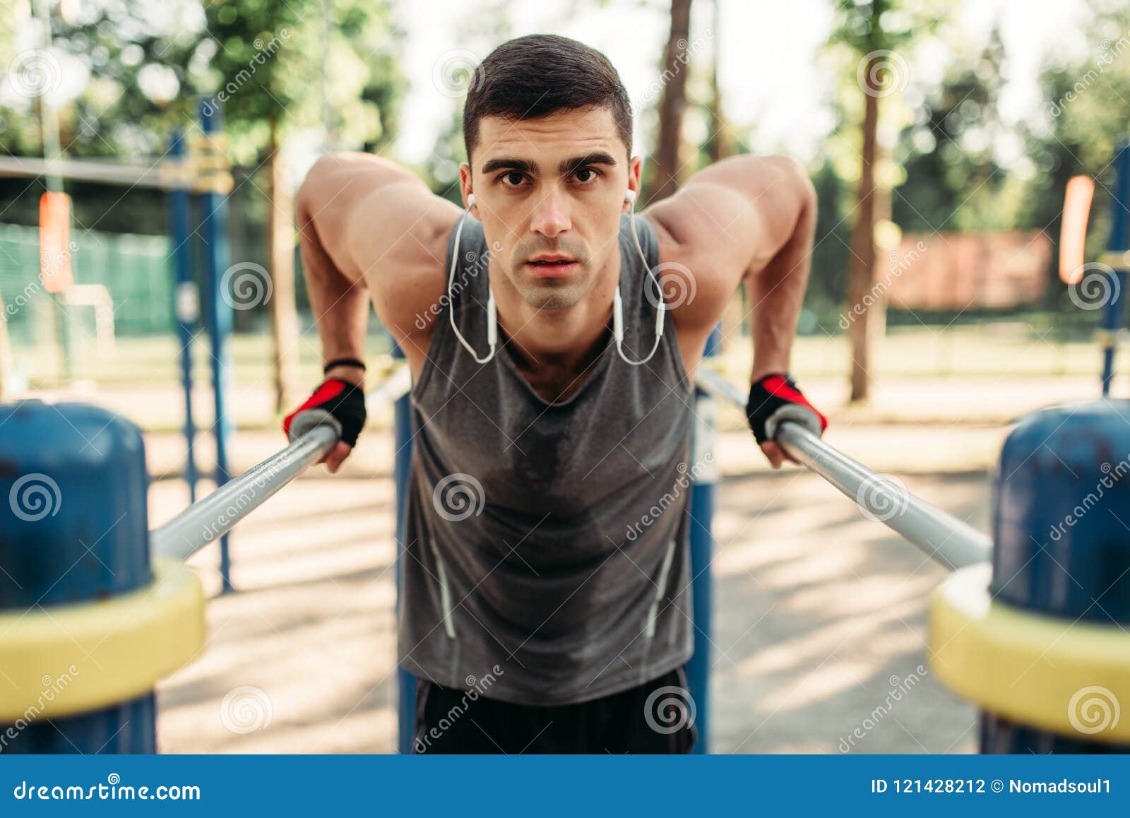 Man Doing Exercise on Parallel Bars, Front View Stock Photo - Image of ...