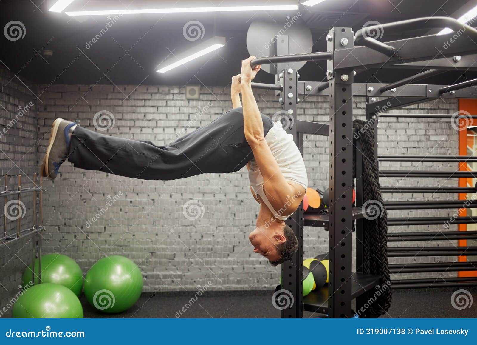 Man Doing Exercises on Horizontal Bar in Gym Stock Photo - Image of ...