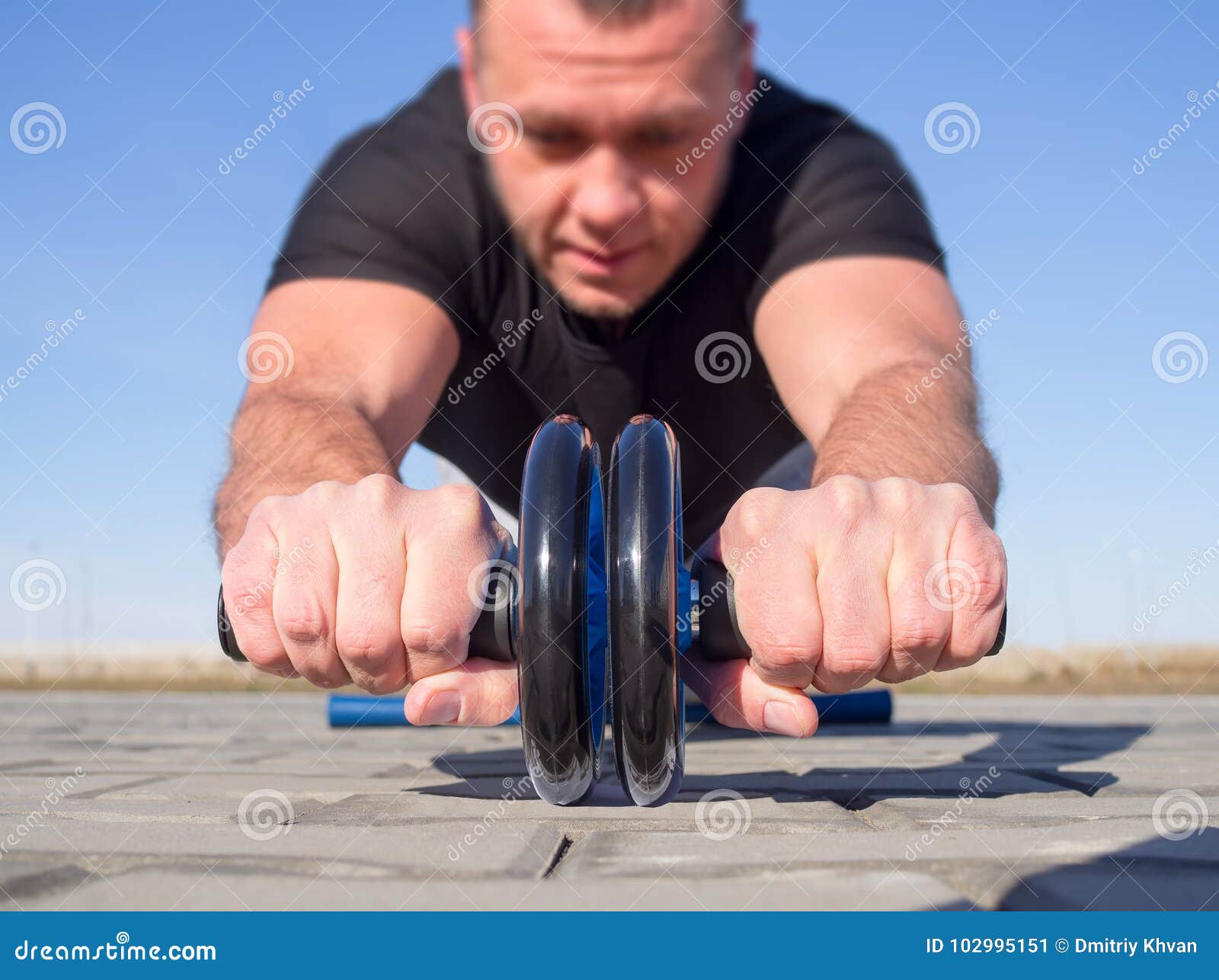 Man Doing Exercises with a Power Wheel Outdoor. Stock Image - Image of ...