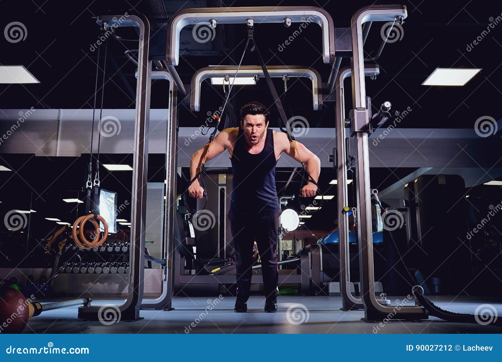 A Man is Doing Exercises on Simulator in the Gym Stock Photo - Image of ...