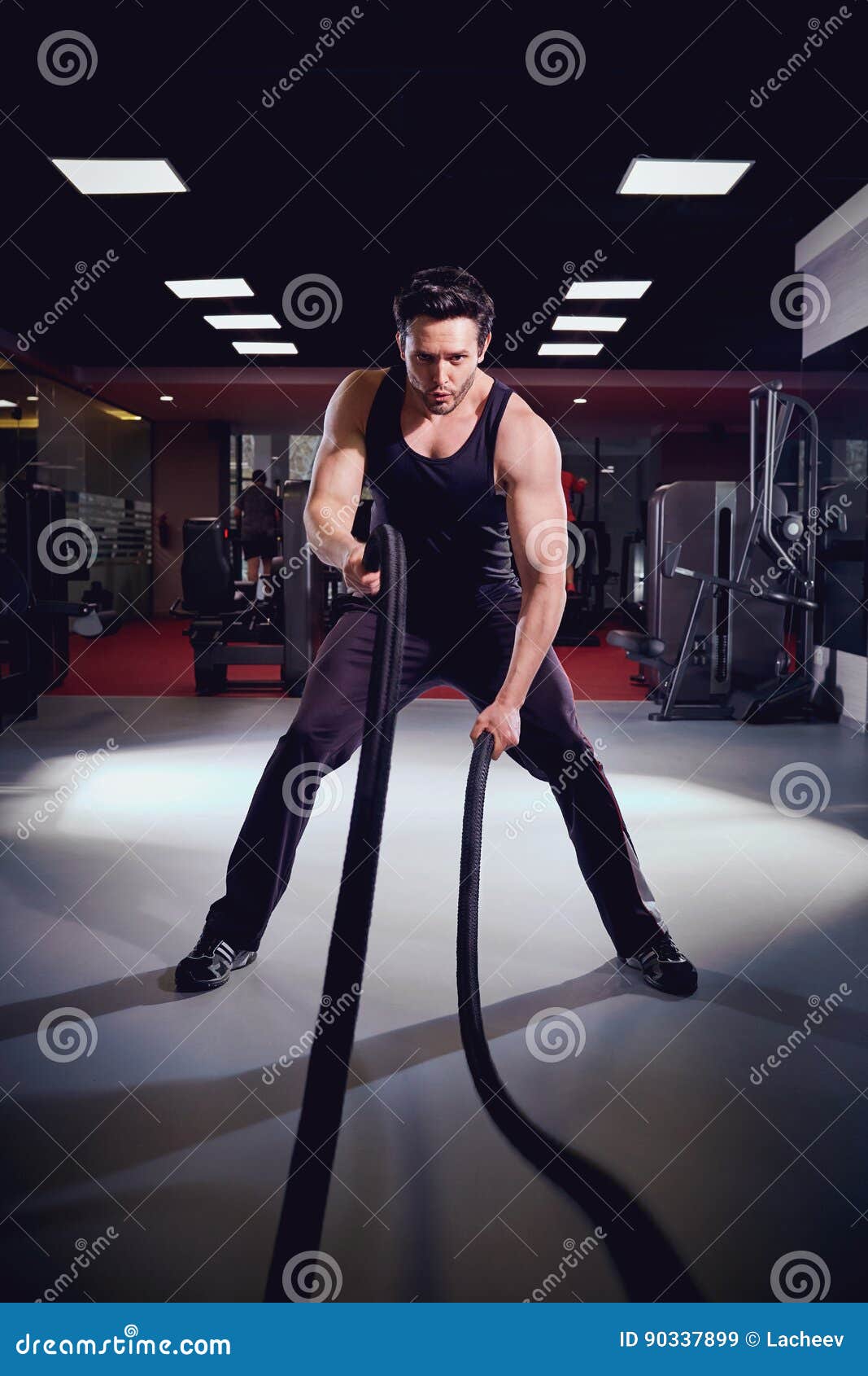 Man is Doing Exercises Working Out with a Rope in the Gym Stock Image ...