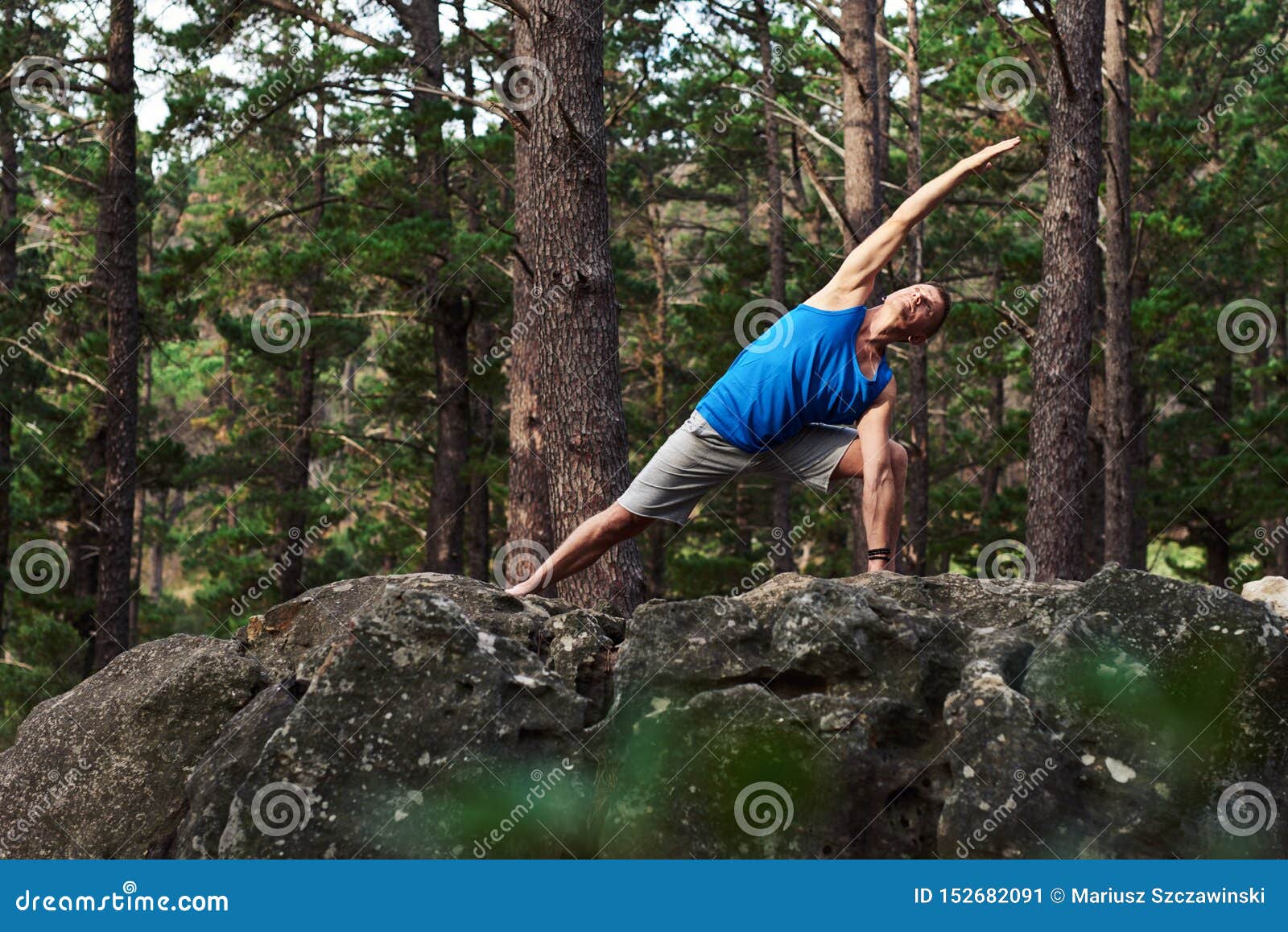 Man Doing the Extending Side Angle Pose in a Forest Stock Image - Image ...