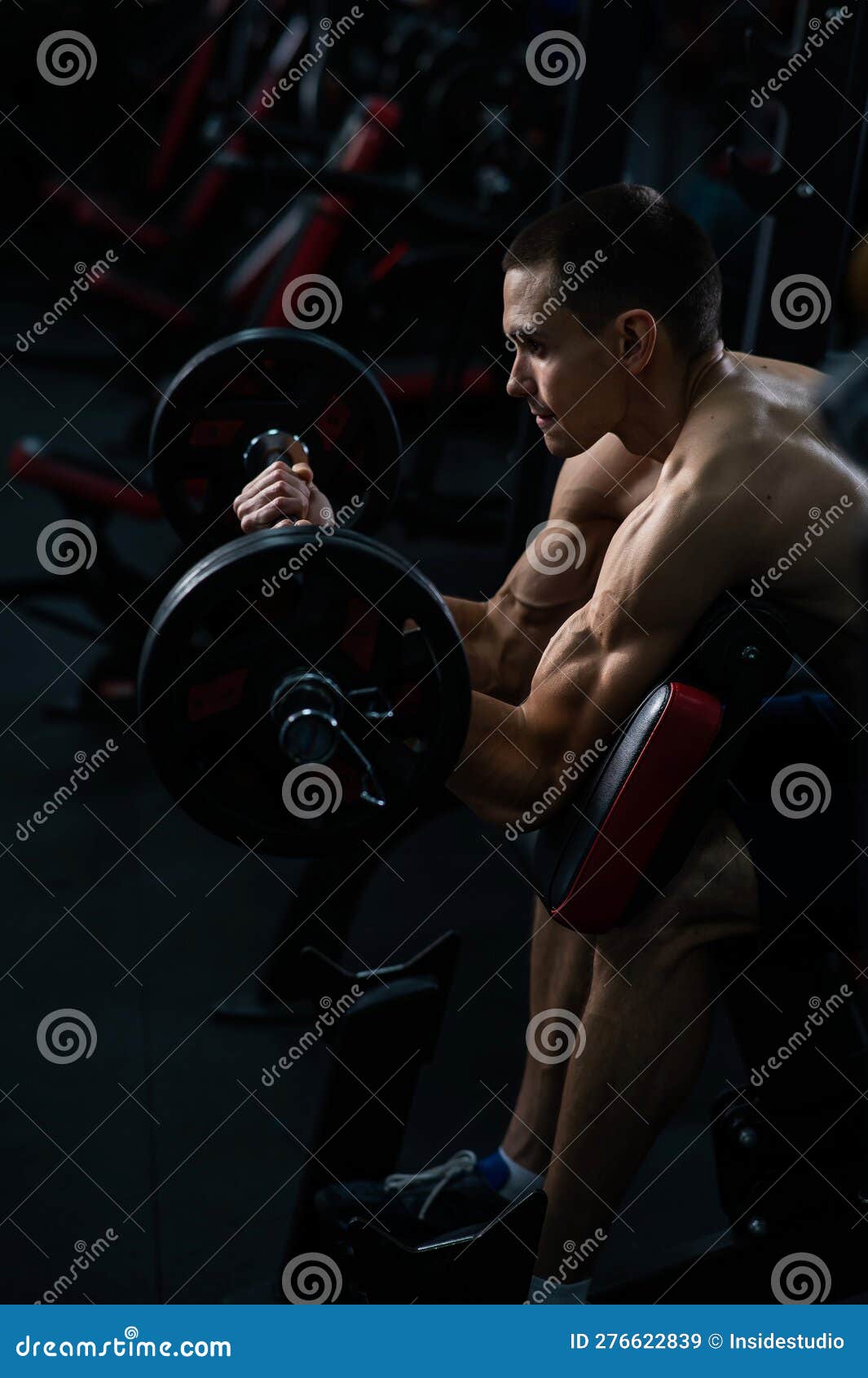 Man Doing Ez Barbell Bicep Exercises On Scott Bench Stock Image