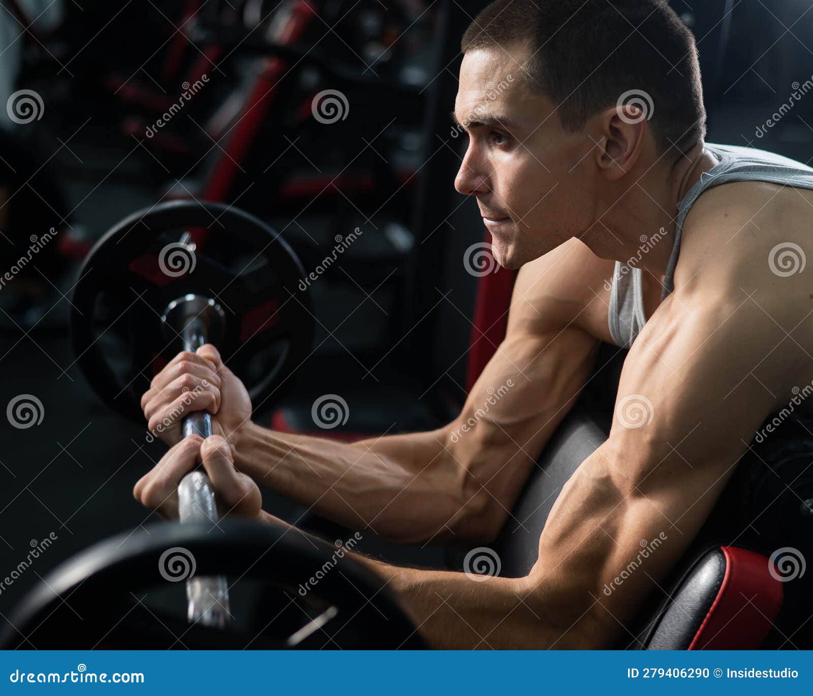 Man Doing EZ Barbell Bicep Exercises on Scott Bench. Stock Photo ...