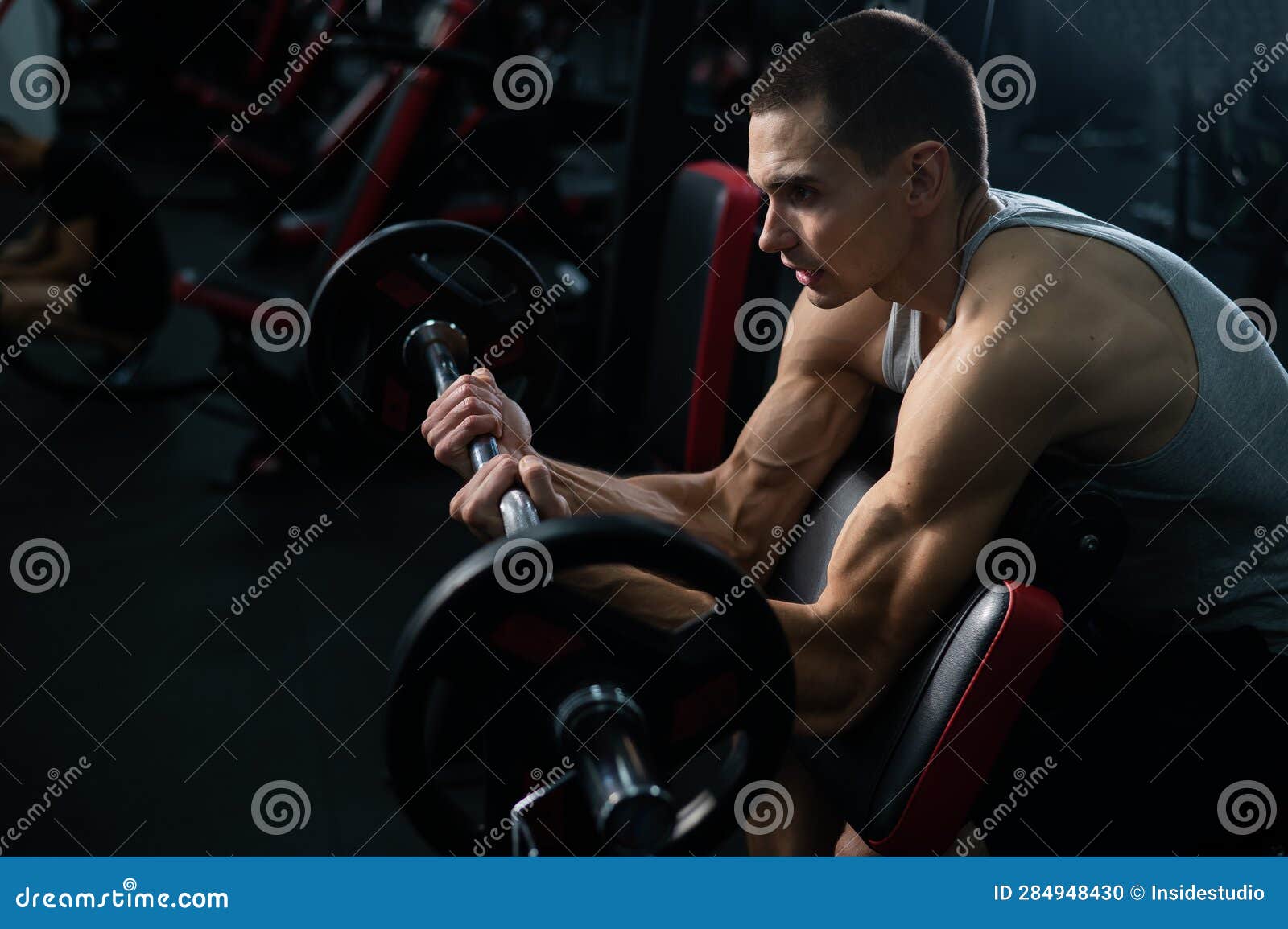 Man Doing EZ Barbell Bicep Exercises on Scott Bench. Stock Photo ...