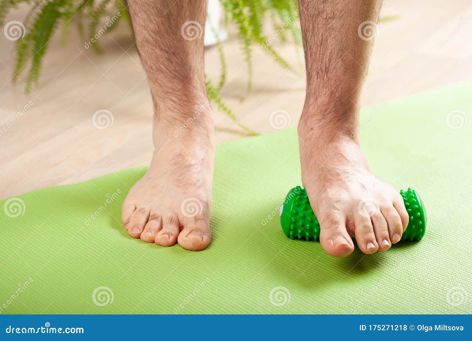 Man Doing Flatfoot Correction Gymnastic Exercise Using Massage Roller ...