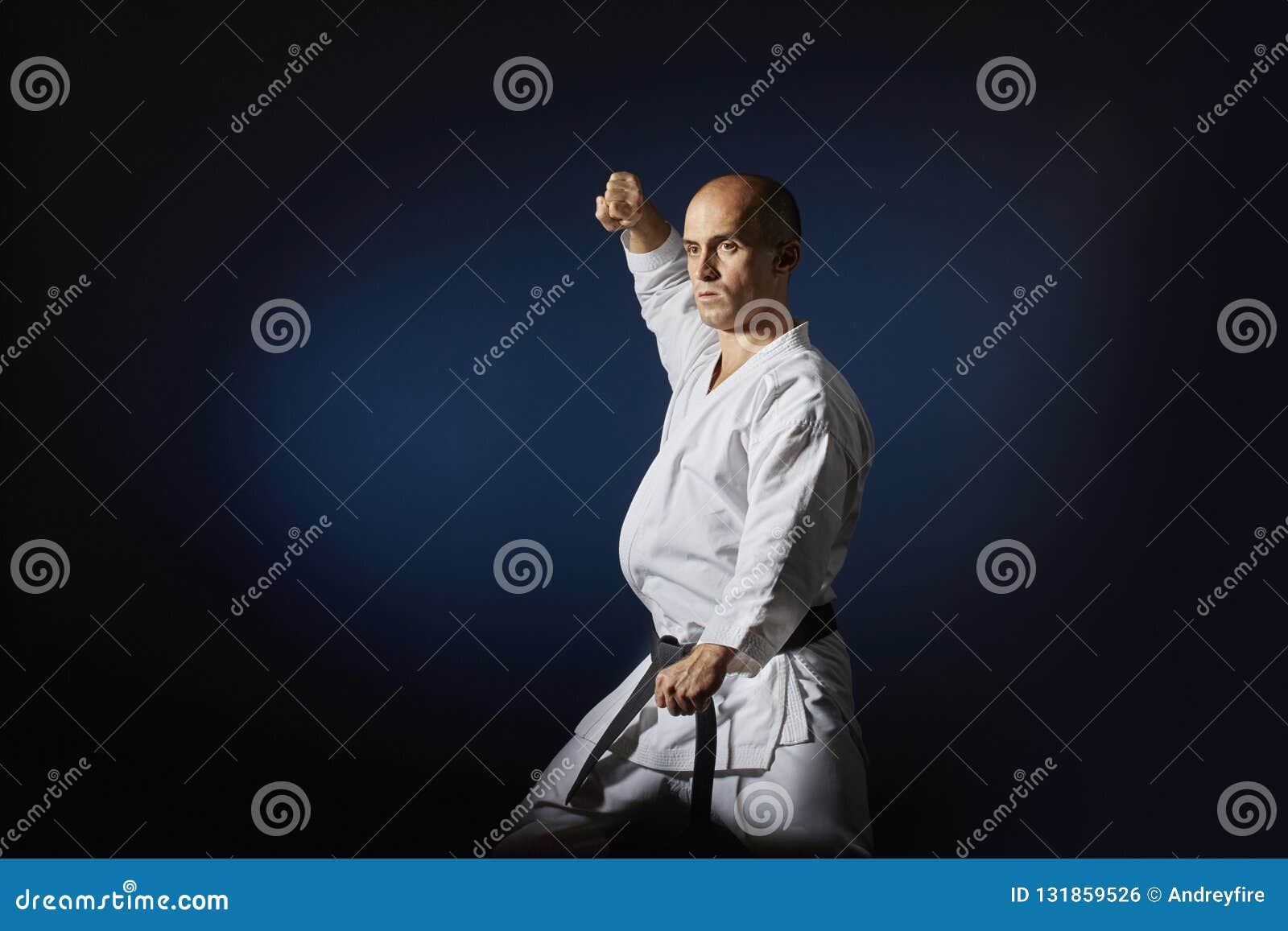 Athlete Doing Formal Karate Exercises on Blue Background with Gradient ...