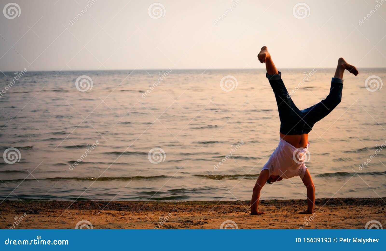 Man Doing Handstand on Beach Stock Image - Image of ocean, male: 15639193