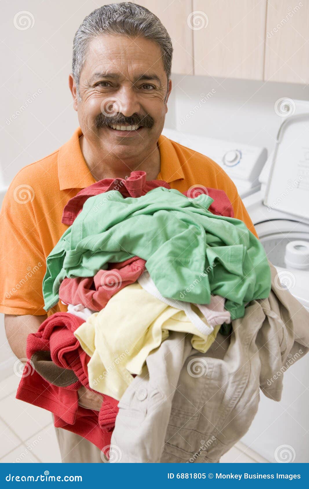 Man Doing Laundry stock image. Image of machine, holding - 6881805
