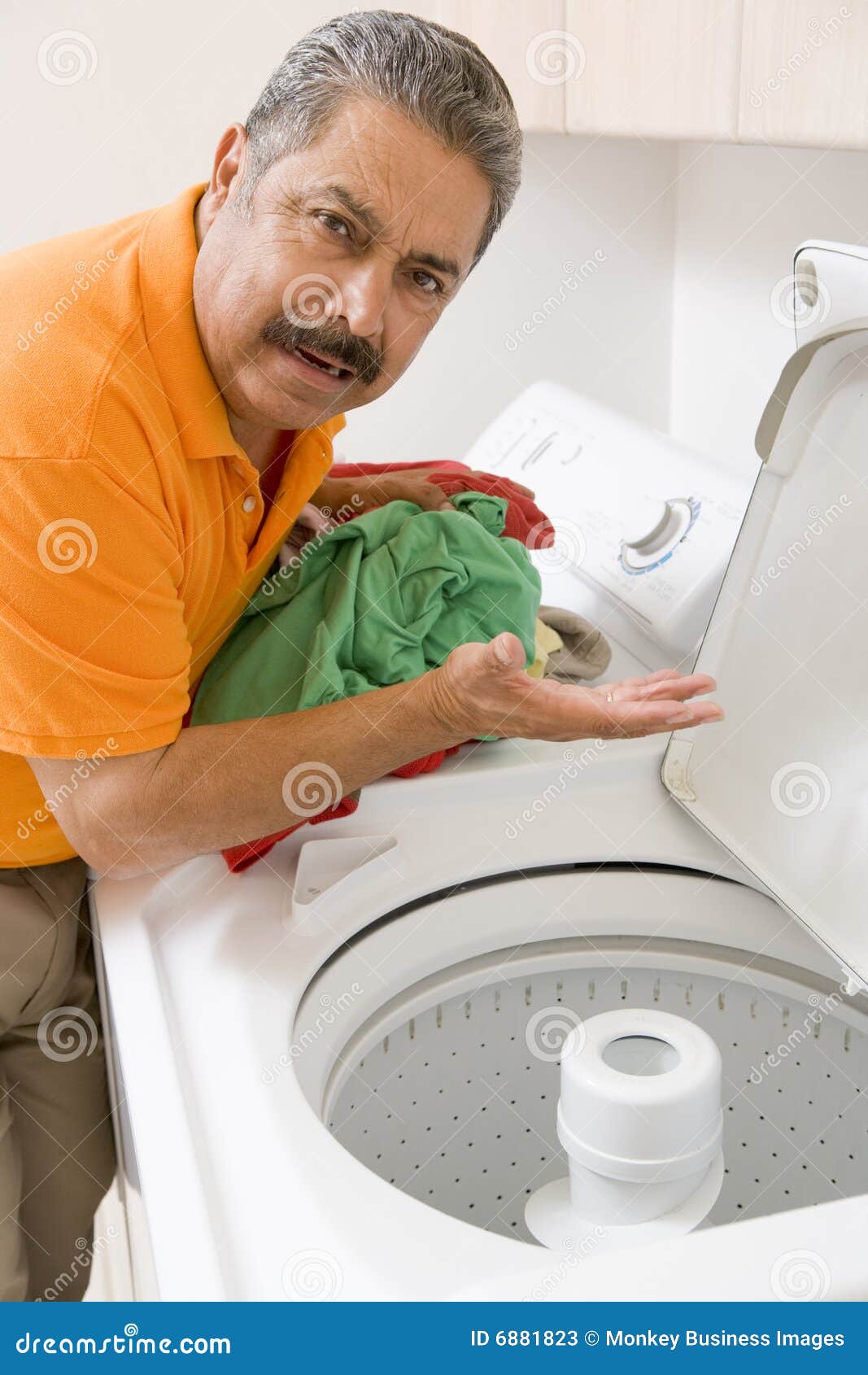 Man Doing Laundry stock image. Image of inside, latino - 6881823