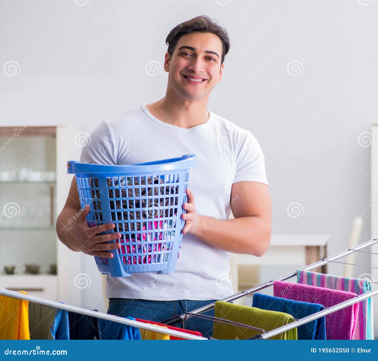 Man doing laundry at home stock photo. Image of clothespin - 195652050