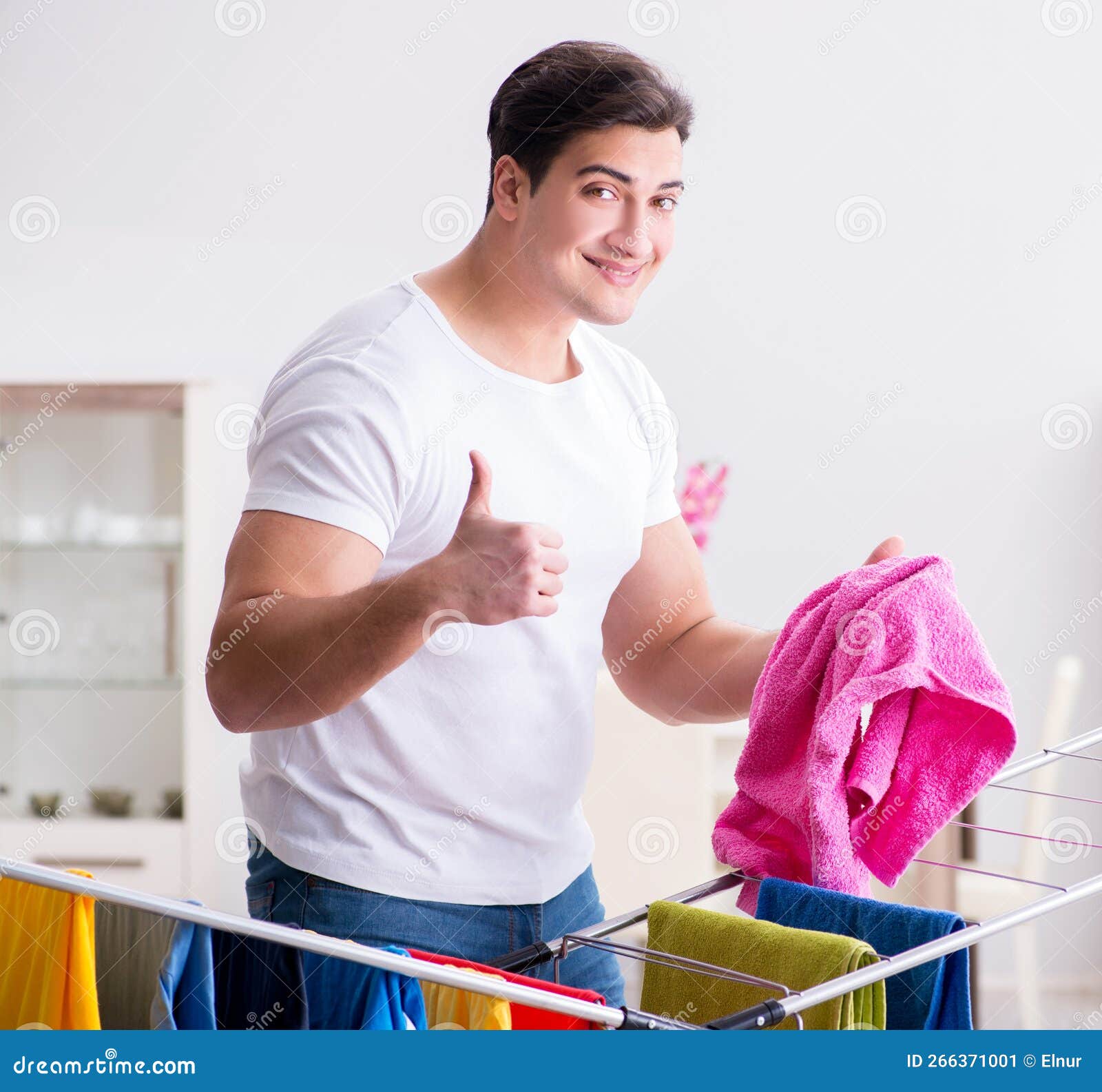 Man doing laundry at home stock image. Image of clothing - 266371001