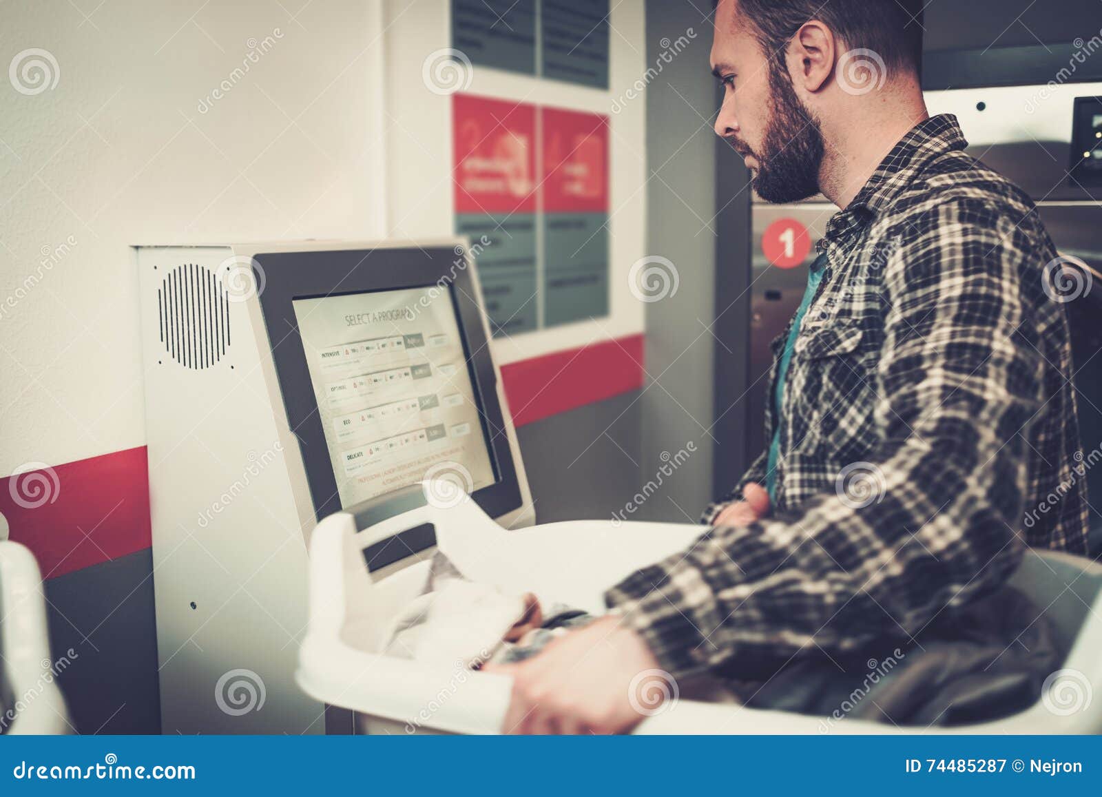 Man Doing Laundry at Laundromat Shop. Stock Image - Image of laundromat ...
