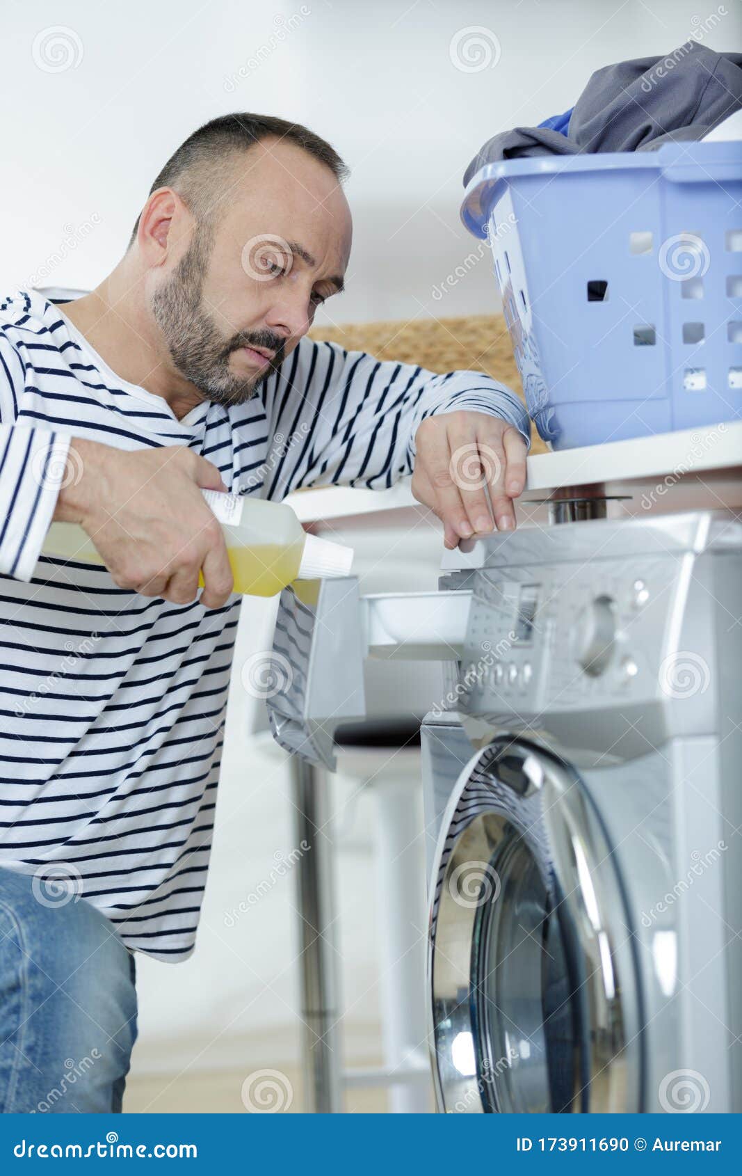 Man Doing Laundry Reaching Inside Washing Machine Stock Photo - Image ...