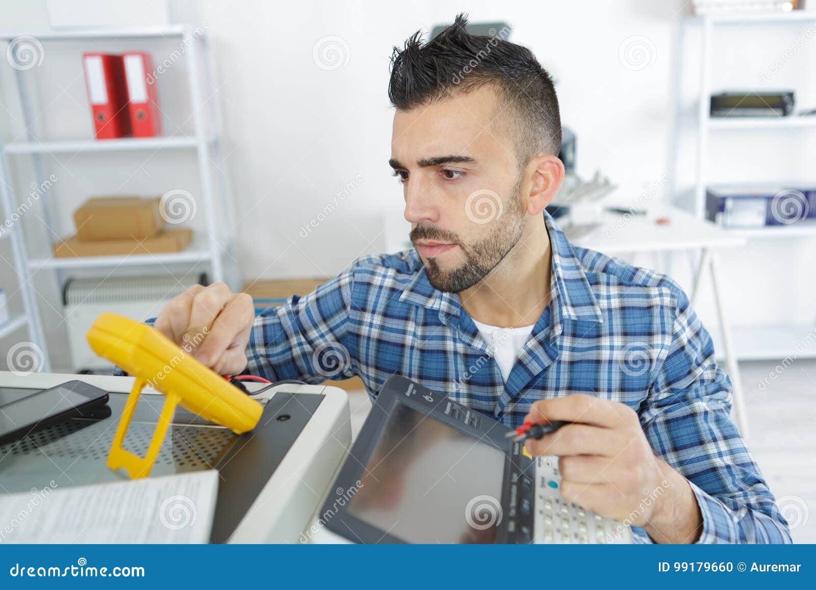 Man Doing Maintenance Repairs on Printer Using Multimeter Stock Photo ...