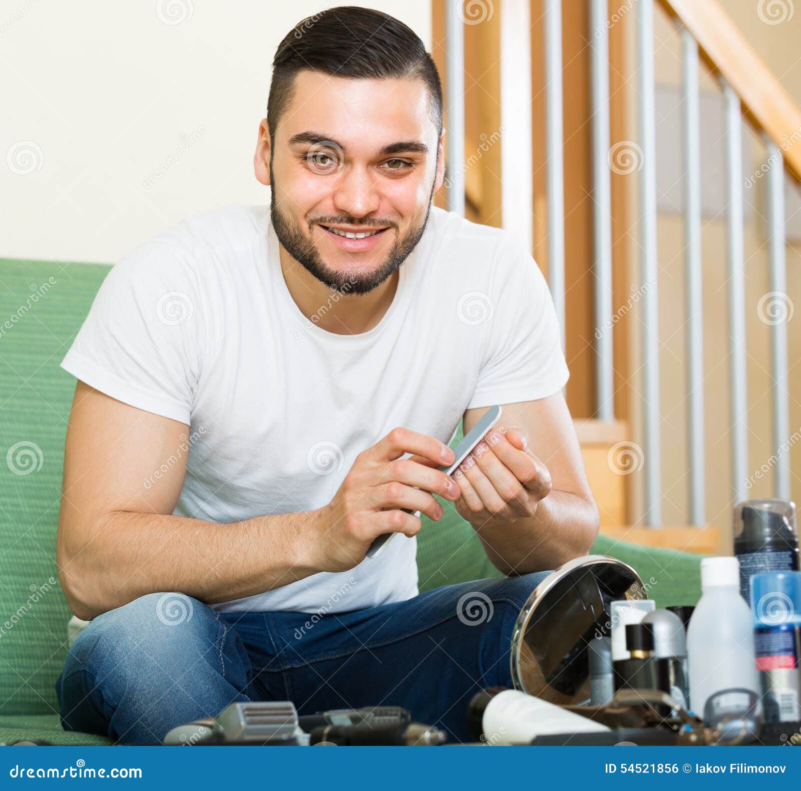 Man doing manicure at home stock photo. Image of nails - 54521856