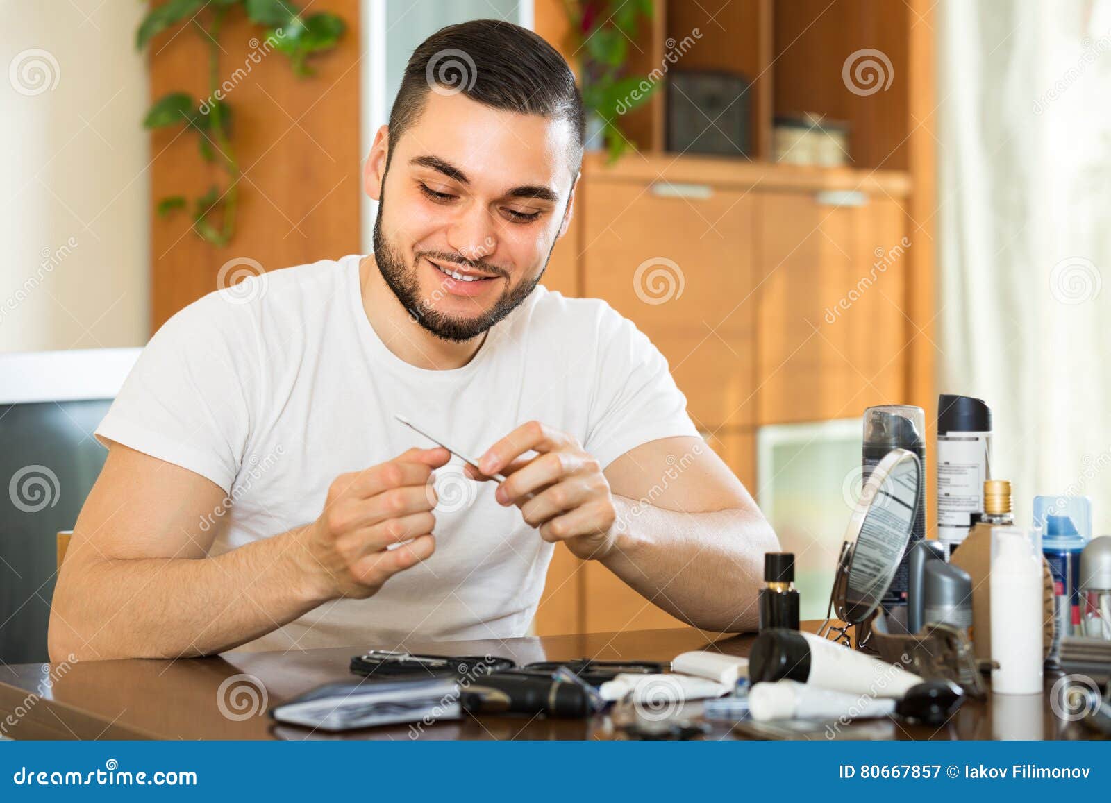 Man doing manicure at home stock image. Image of file - 80667857