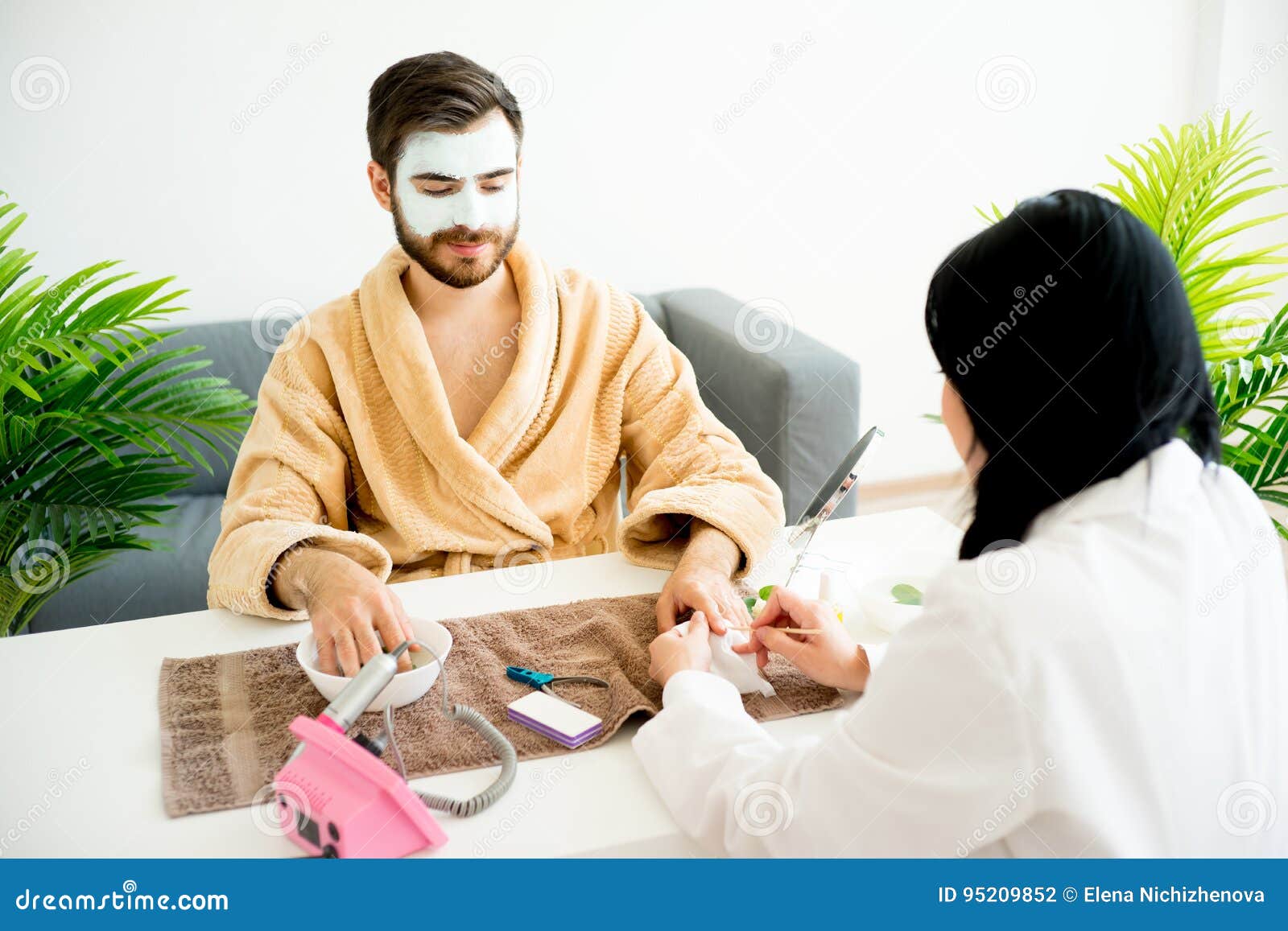 Man doing manicure stock photo. Image of lying, facial - 95209852