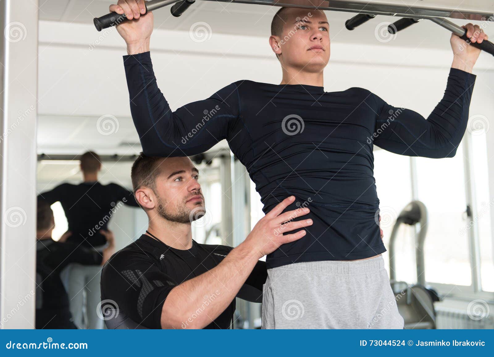 Man Doing Pull-Ups Exercises with Gym Coach Stock Photo - Image of ...