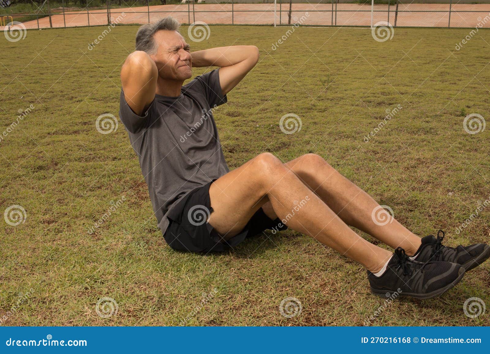 Man doing sit ups outside stock photo. Image of wellness - 270216168
