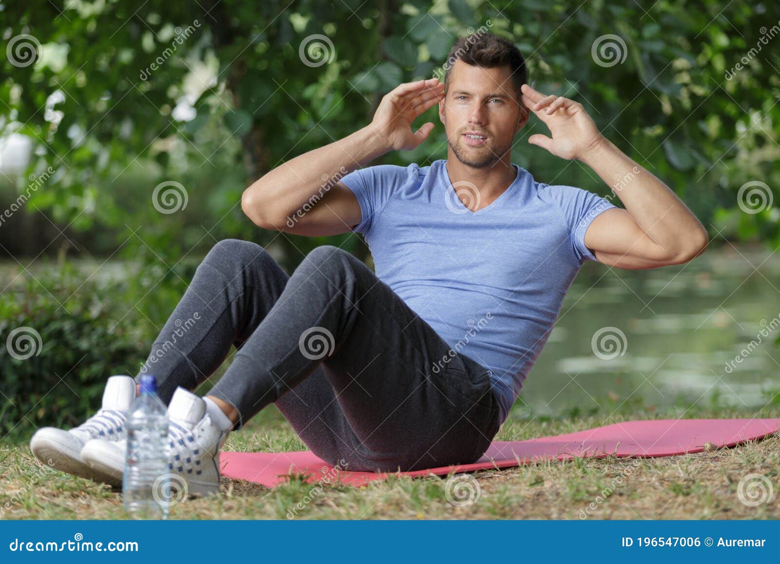 Man doing sit ups at park stock photo. Image of exercising - 196547006