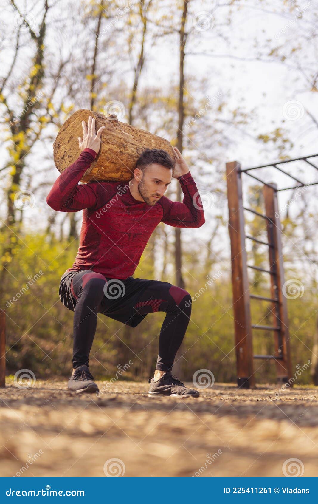 Man Doing Squats while Lifting a Tree Log Outdoors Stock Image - Image ...