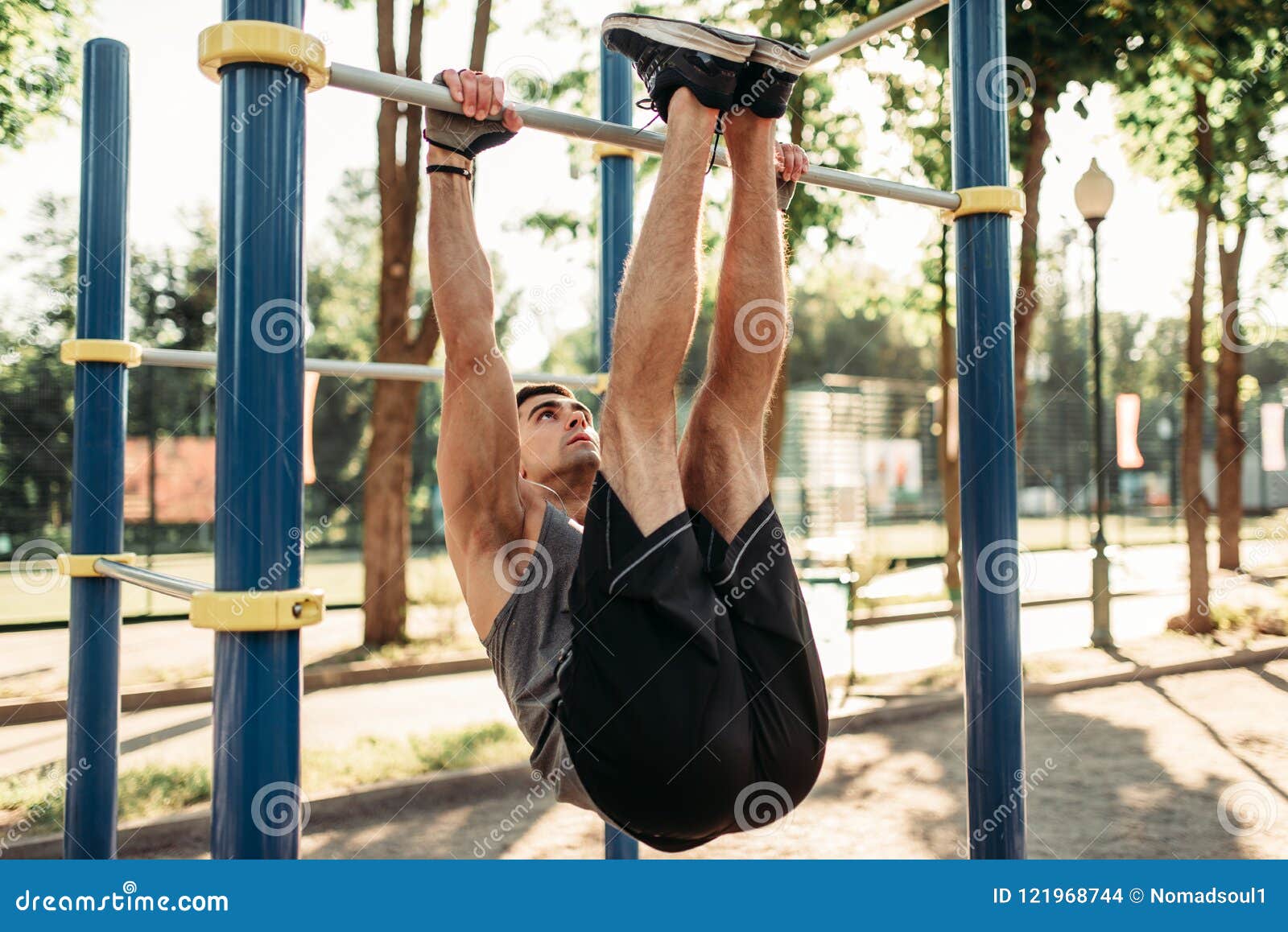 Man Doing Stretching Exercise Using Horizontal Bar Stock Photo - Image ...
