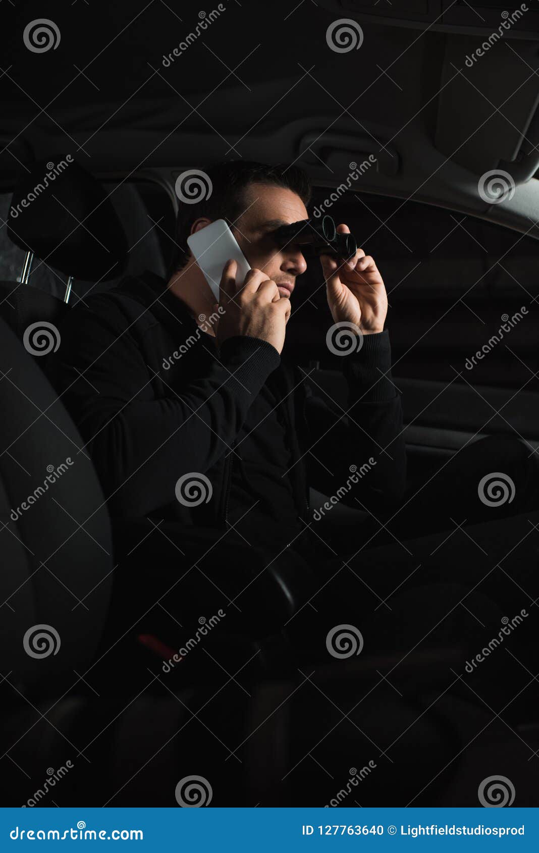 Man Doing Surveillance by Binoculars and Talking on Smartphone Stock ...