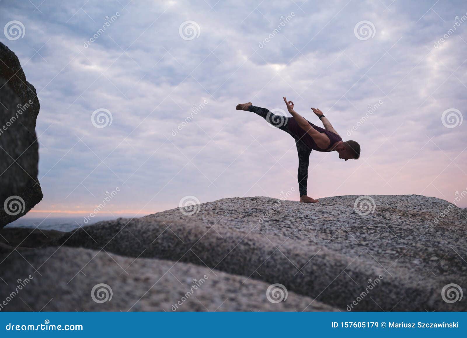Man Doing the Warrior Three Pose on Rocks at Dusk Stock Image - Image ...