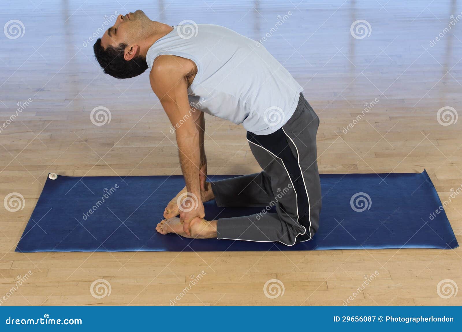 Man Doing Yoga on Mat stock image. Image of activity - 29656087
