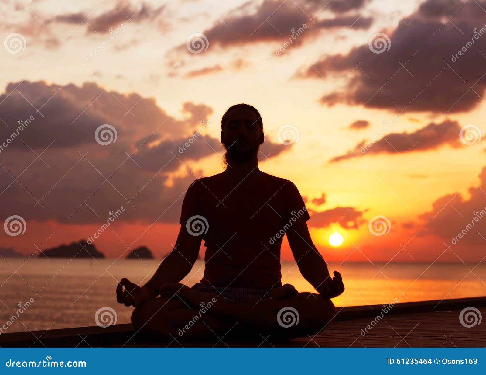 Man doing yoga at sunset stock photo. Image of serene - 61235464