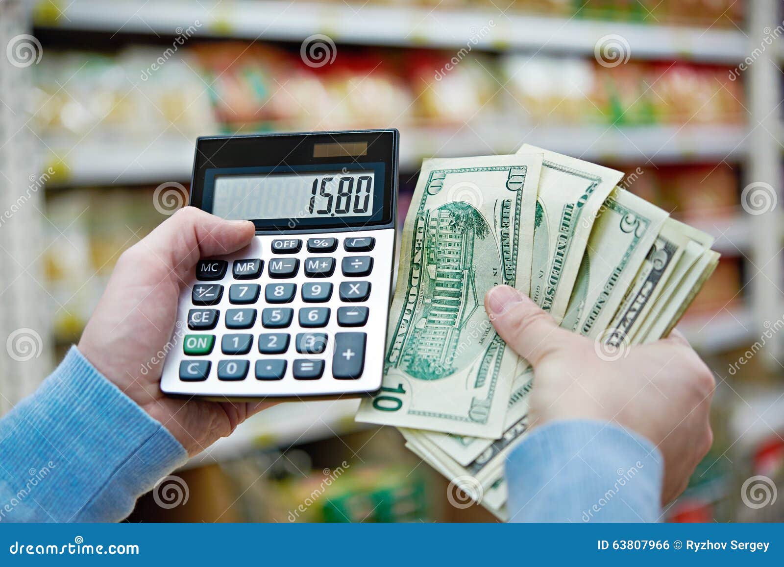 Man with Dollars and Calculator Considers Costs in Store Stock Photo ...