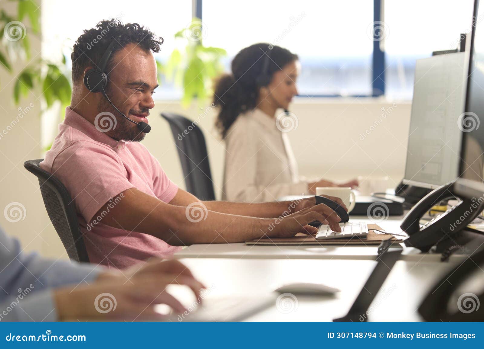 Man with Down Syndrome Wearing Headset Working in Office Call Centre ...