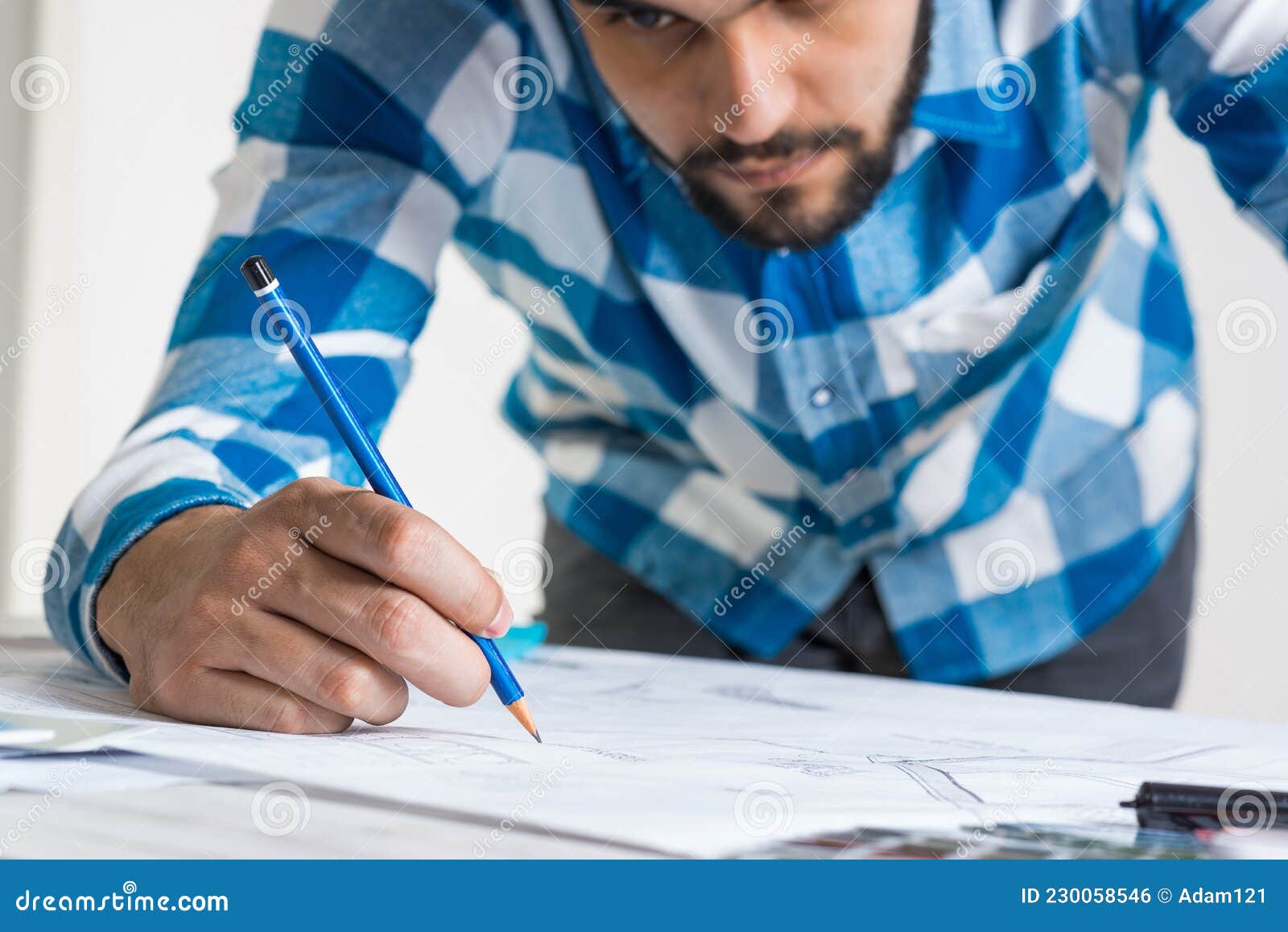 Man Drawing with Pencil on Construction Blueprint. Stock Photo - Image ...