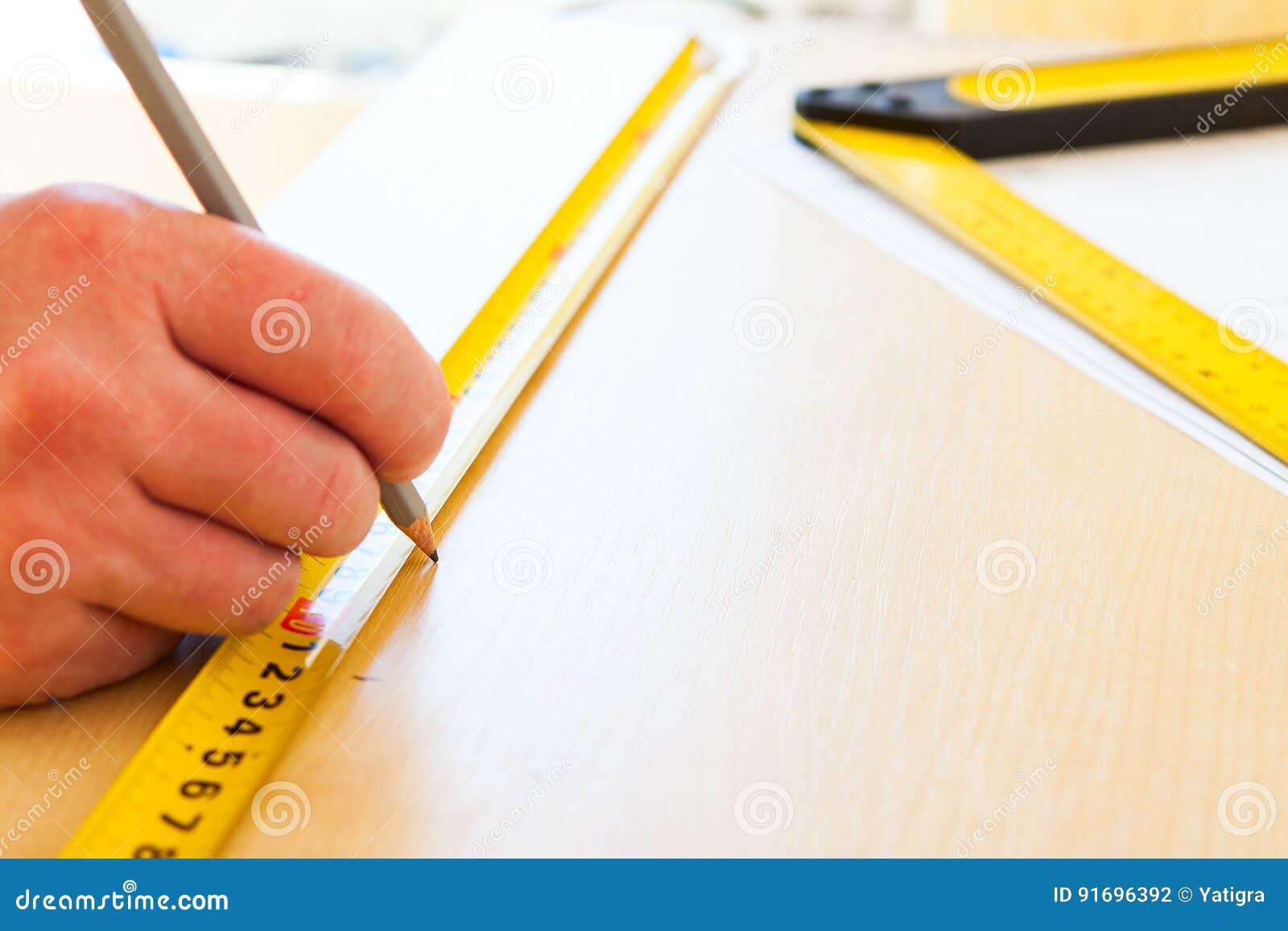 Man Draws on a Sheet of Chipboard Stock Photo - Image of background ...