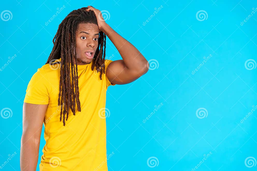 Man with Dreadlocks with Hand on Face and Thoughtful Expression Stock ...