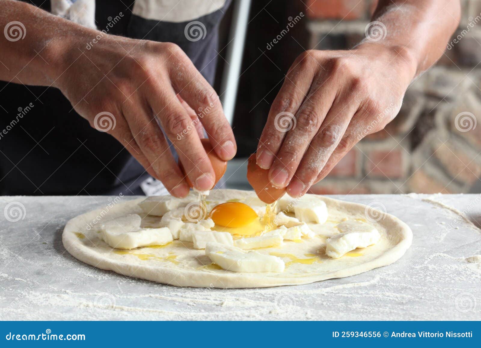 Man Dressing a Pizza with Egg and Mozzarella Cheese with Copy Space for ...