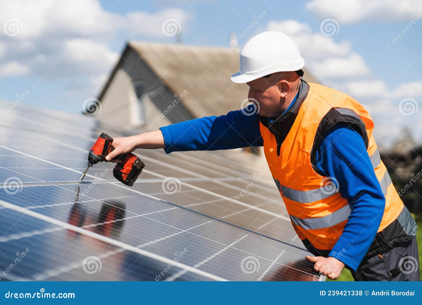 Man with Drill Screwdriver Installs Panels at a Solar Power Plant ...