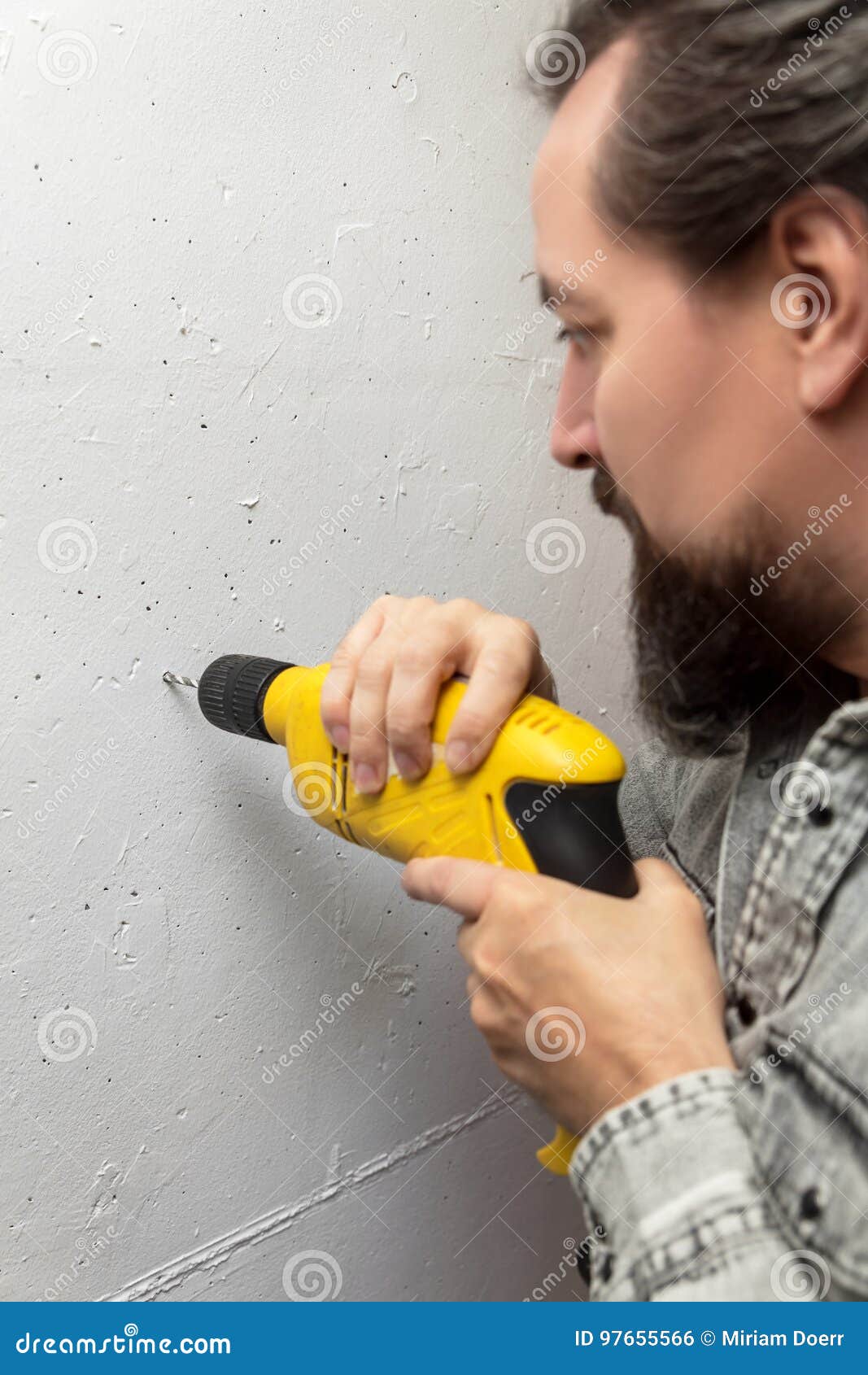 Man Drilling a Hole with a Drill Machine in His Hand Stock Photo ...
