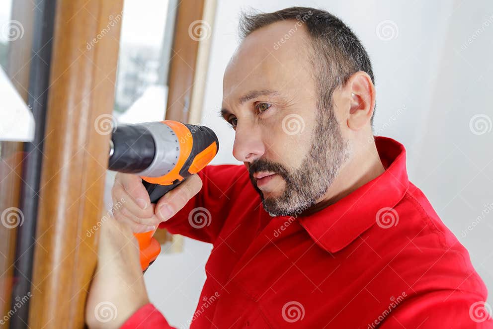 Man drilling window stock image. Image of compression - 204652471